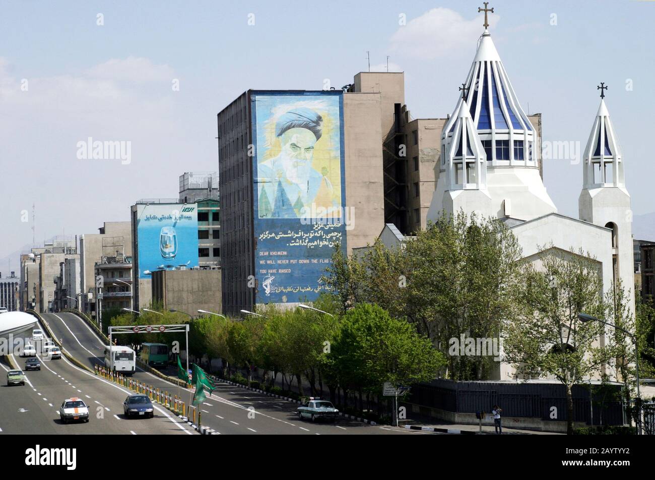 Wallpainting of Ayatollah Khomeiny on a building in the city next to an ...