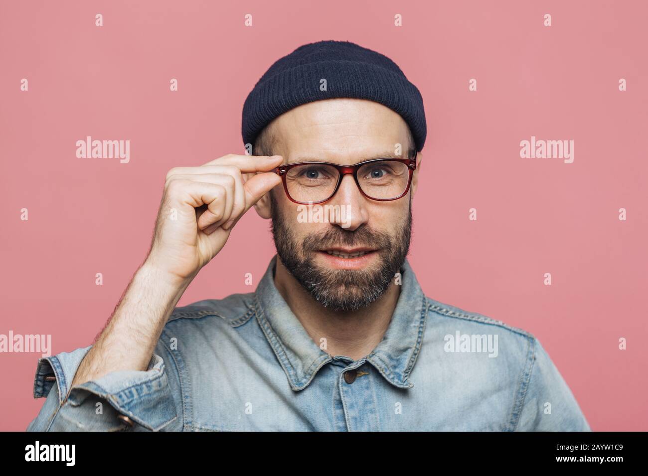 Portrait of pleasant looking satisfied bearded man with pleasant ...