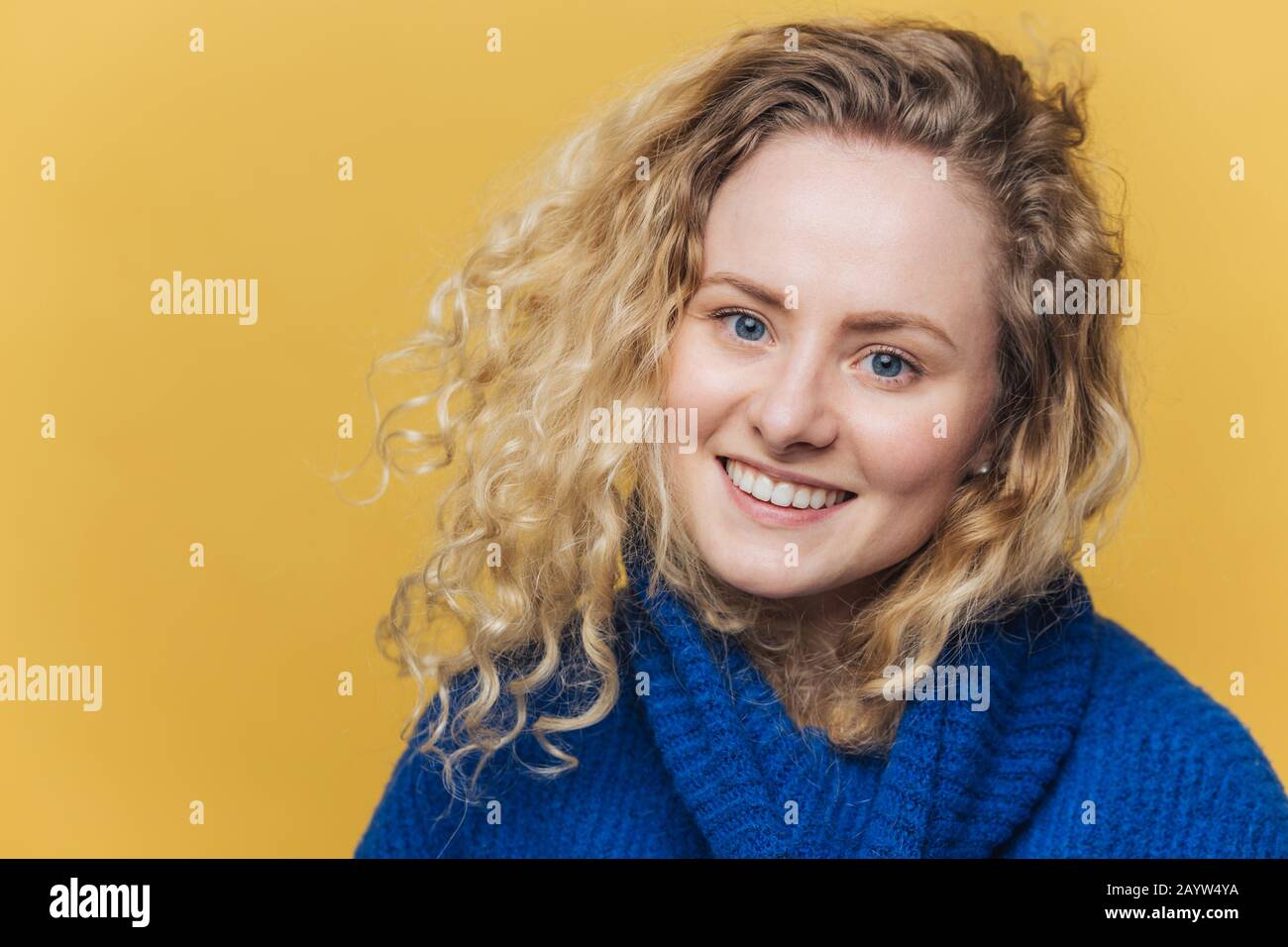 Satisfied happy woman with attractive look, pleasant smile and ...