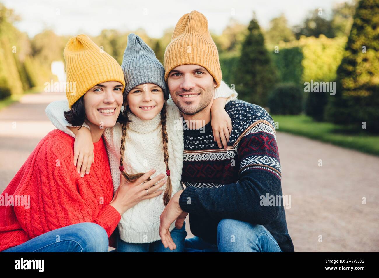 Horizontal portrait of friendly affectionate family hug each other ...