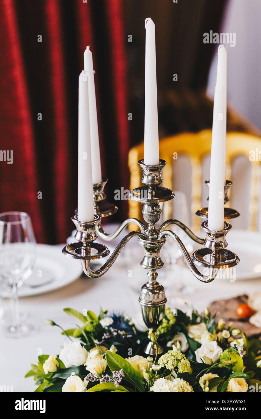 Luxurious banquet table served with beautiful candlestick with white ...
