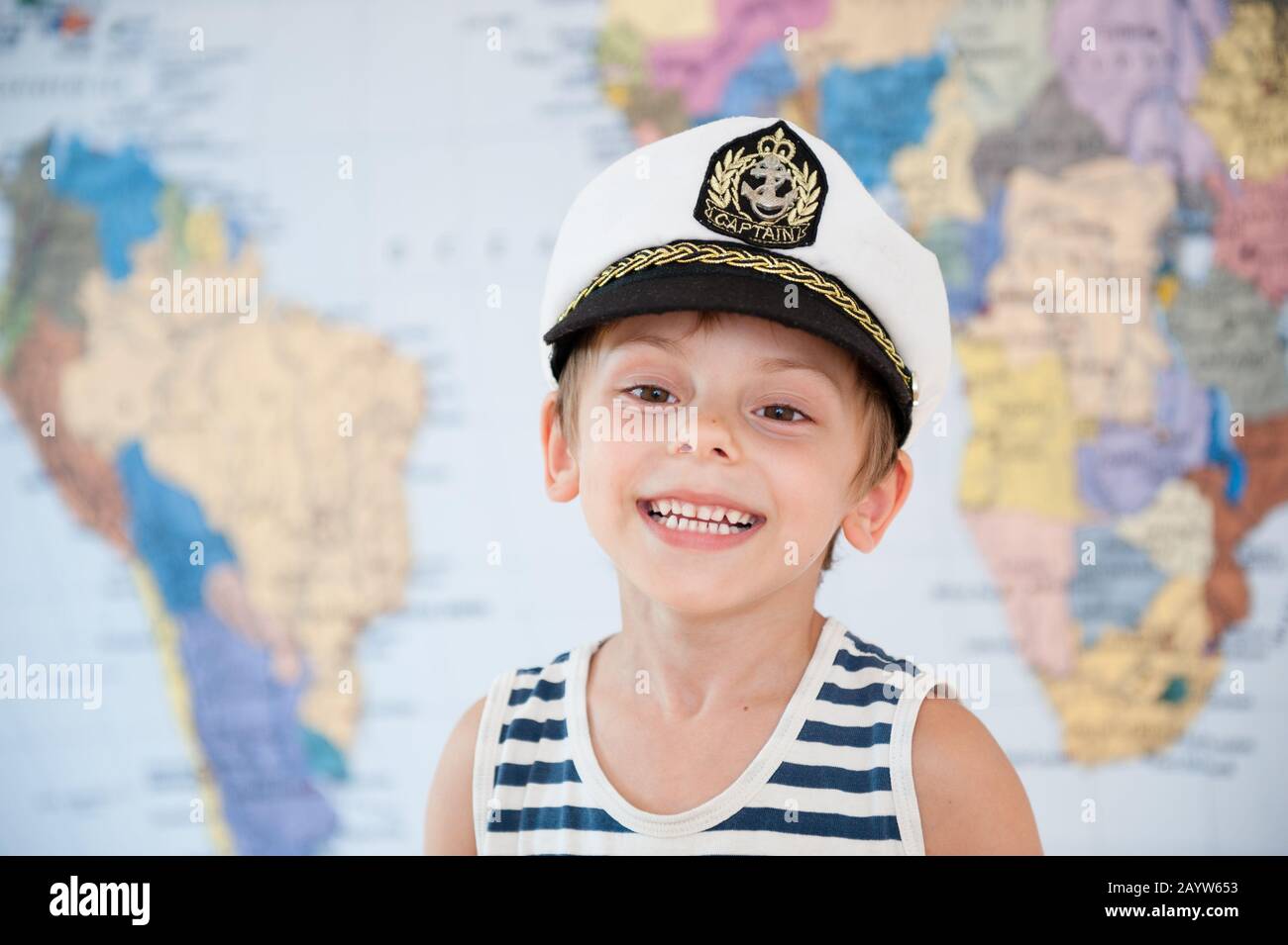 around world cruise concept of happy smiling small child in captain hat ...