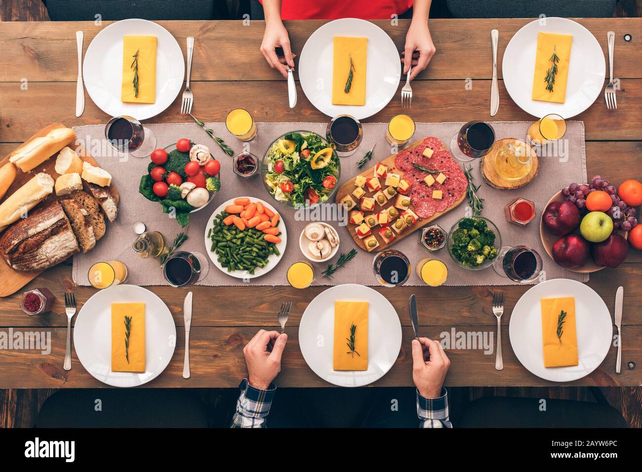 Two people sitting at home behind table with food Stock Photo - Alamy