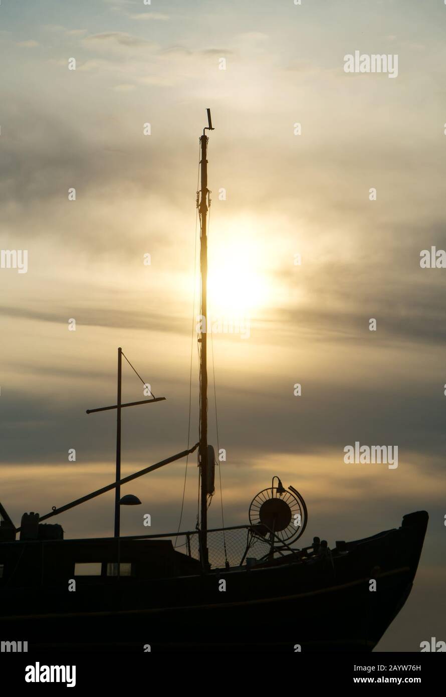 Old ship with a mast without a sail on the sunset Stock Photo - Alamy
