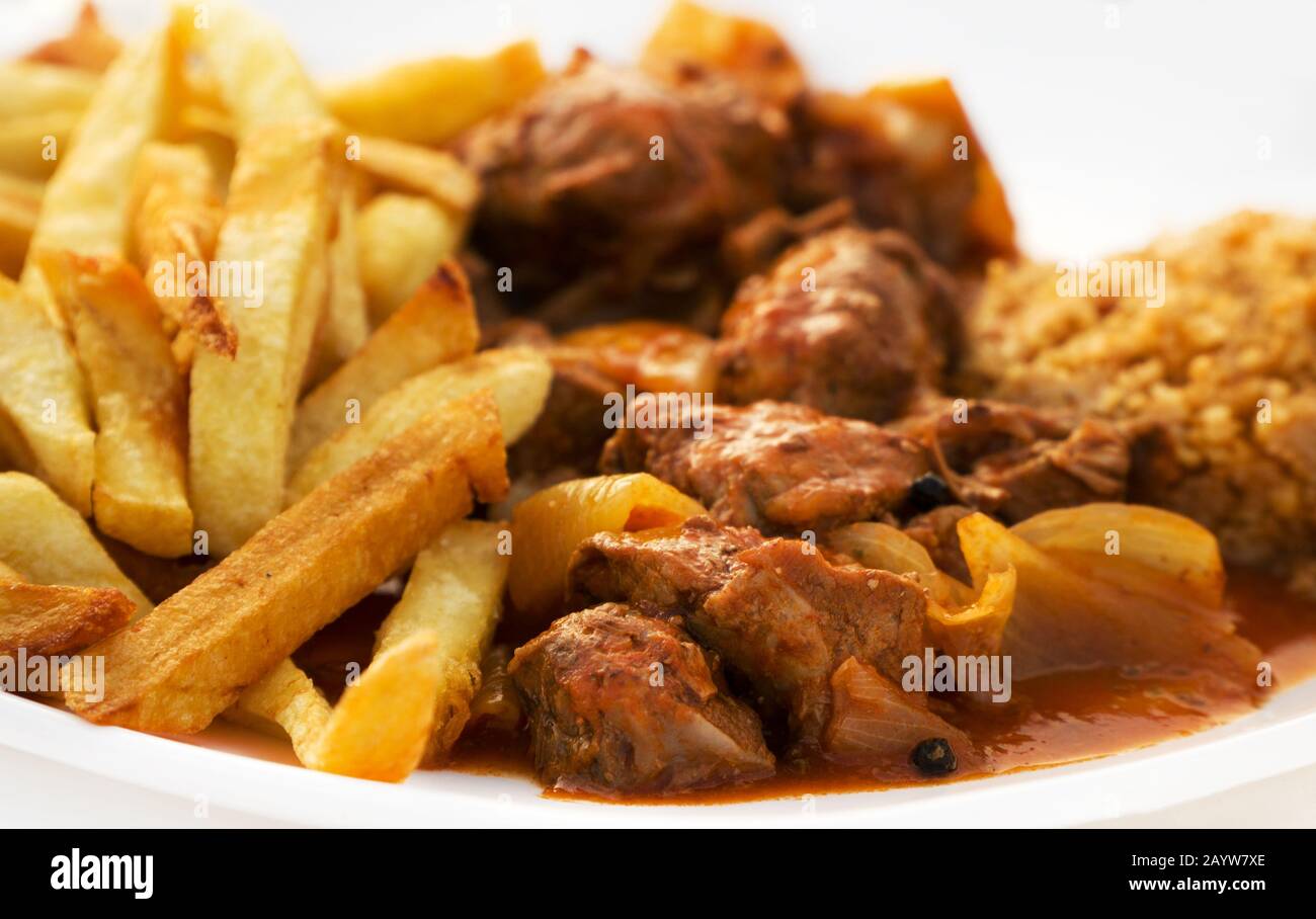 Traditional Greek Beef Stifado with rice and french fries Stock Photo ...