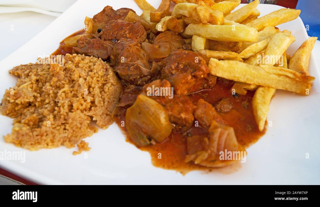 Traditional Greek Beef Stifado with rice and french fries Stock Photo ...