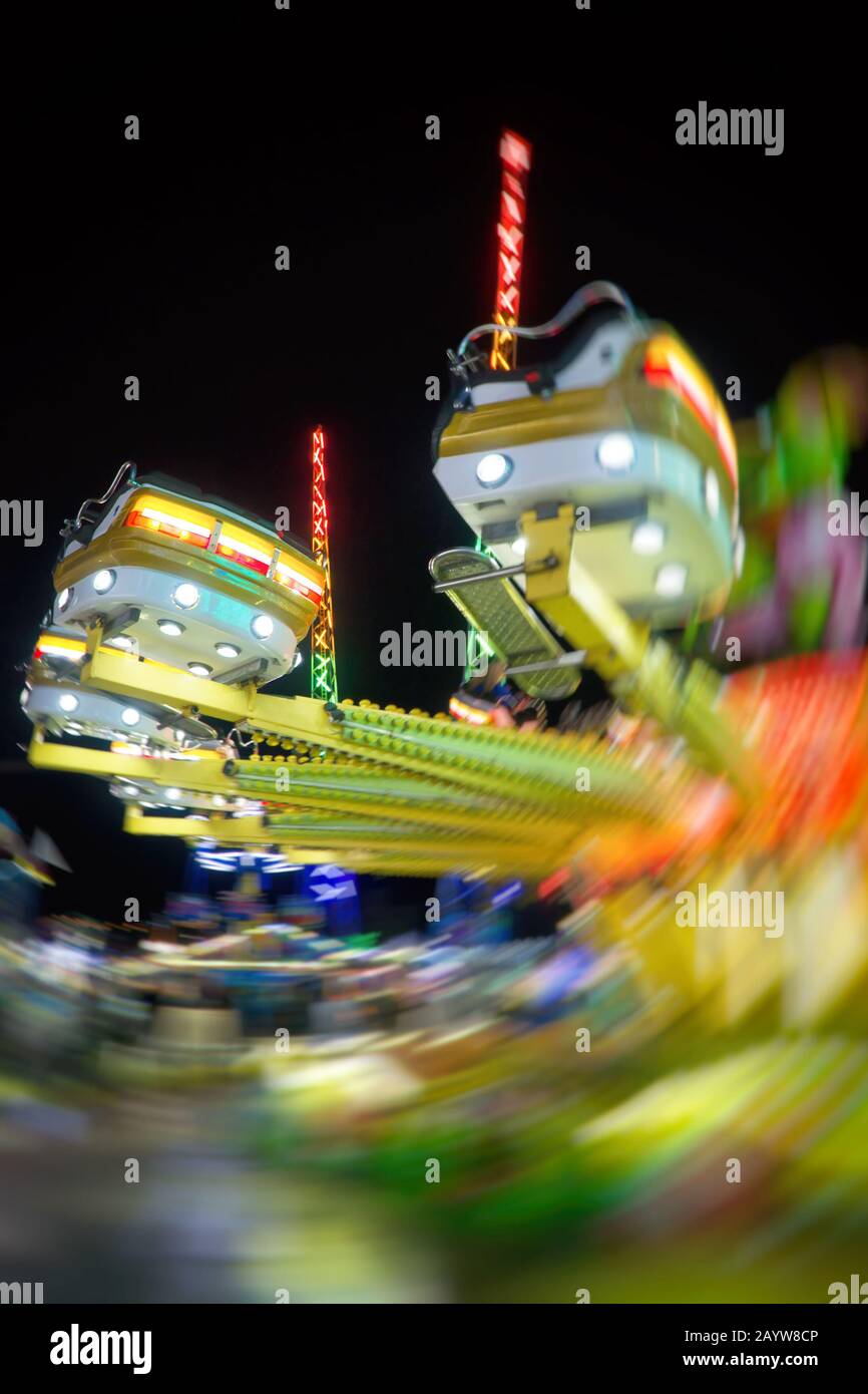 Hurricane ride in the city amusement park at evening Stock Photo - Alamy