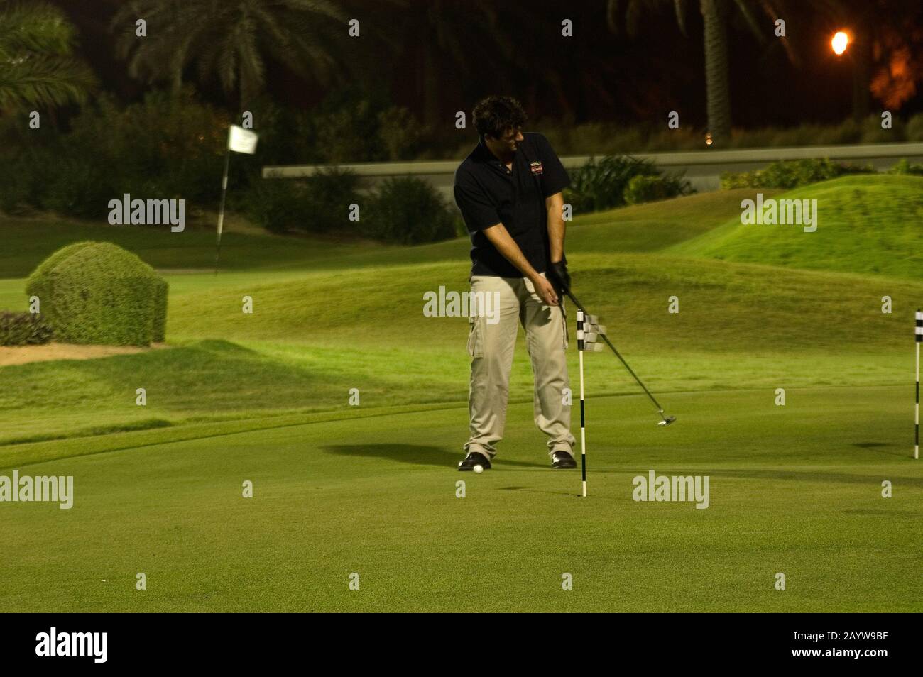 Playing golf at night in Dubai Stock Photo - Alamy