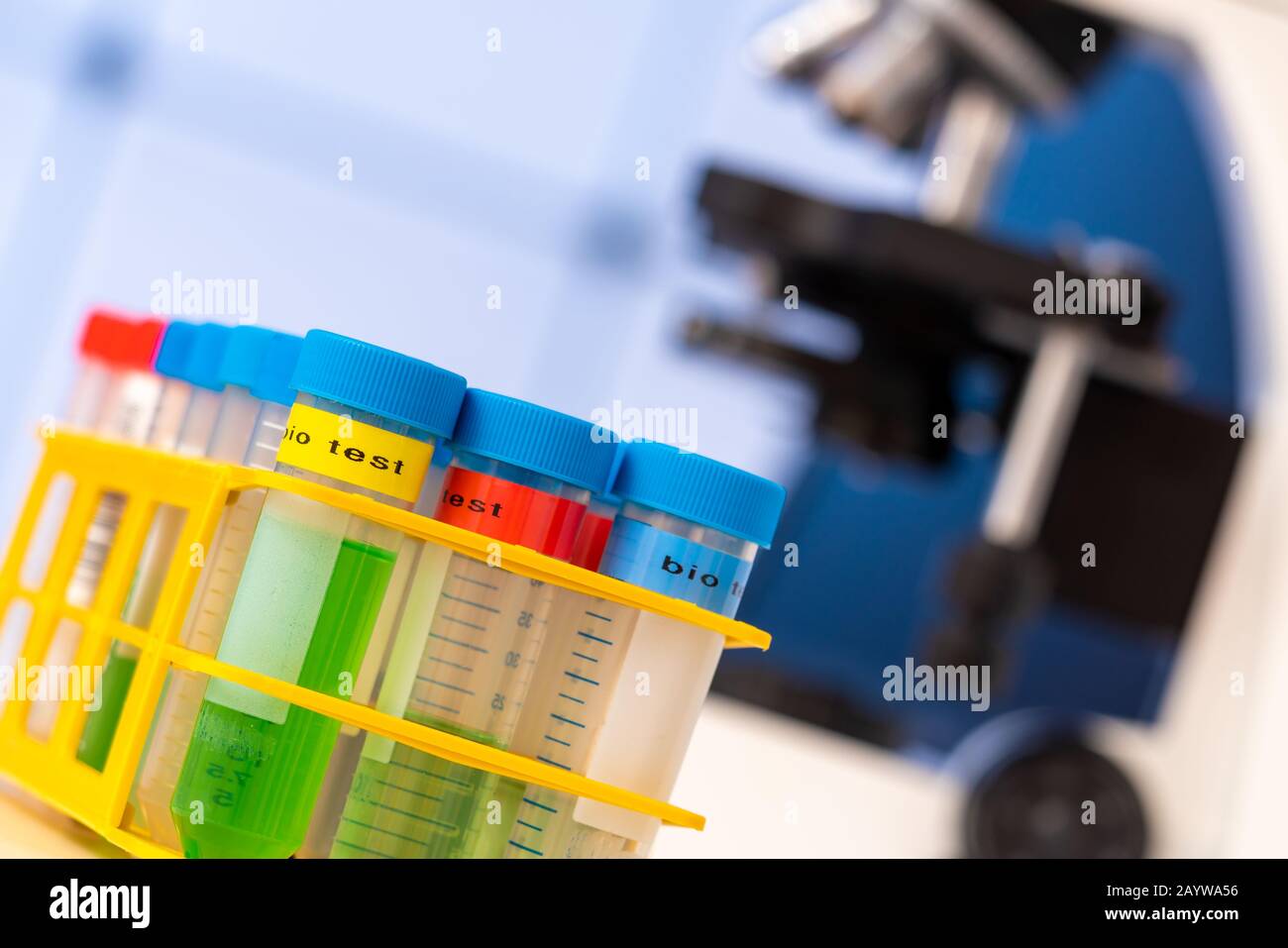 Scientific experiment in microbiological lab. Microscope and test tube ...