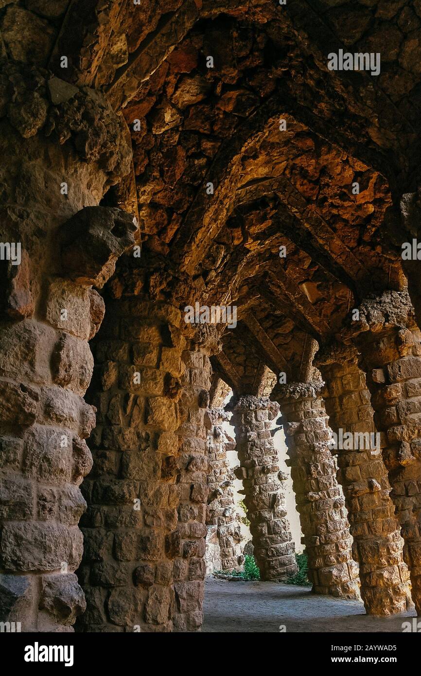Stone arches and columns designed by architect Antoni Gaudi in Parc ...