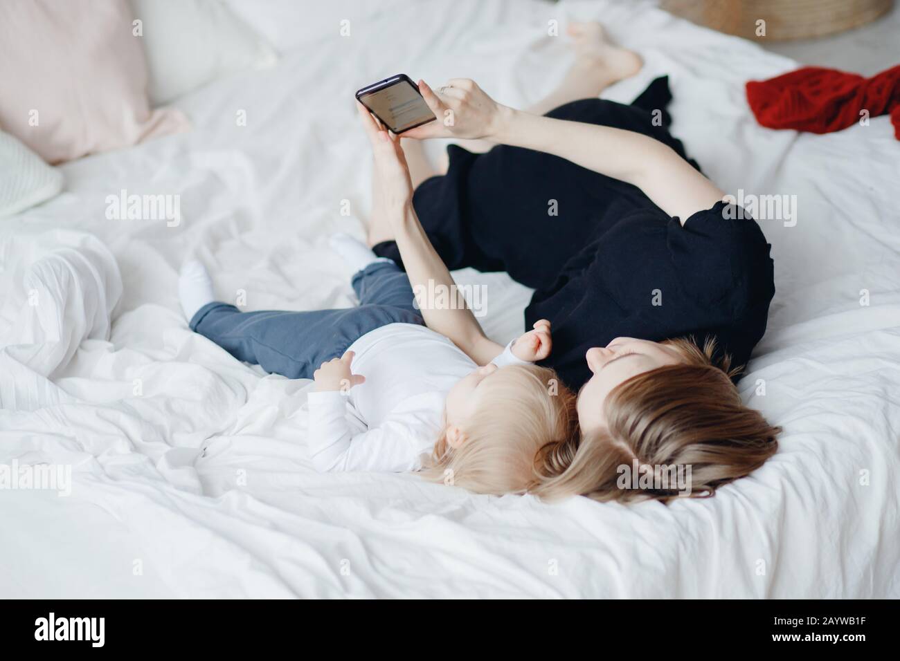 Young mother and her child use telephone call parents via online video ...