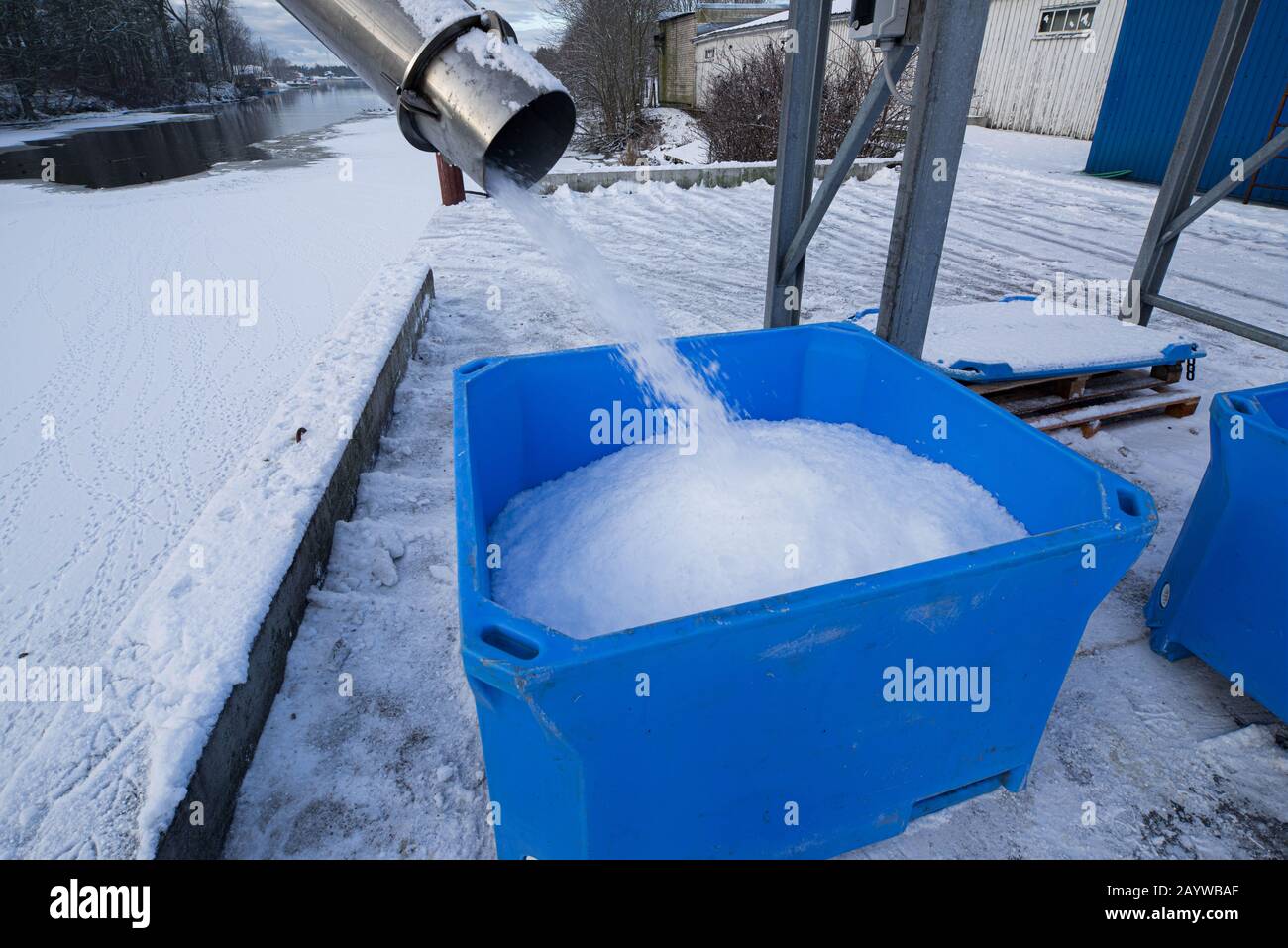 Close-up of the process of snow removal. Snow flying from a metal pipe ...