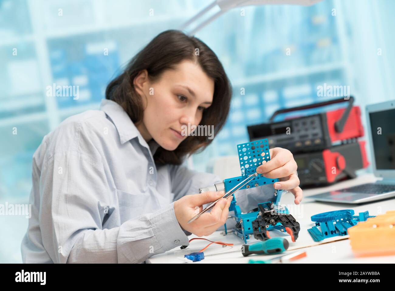 Student woman in robotics laboratory working on project mechatronics ...