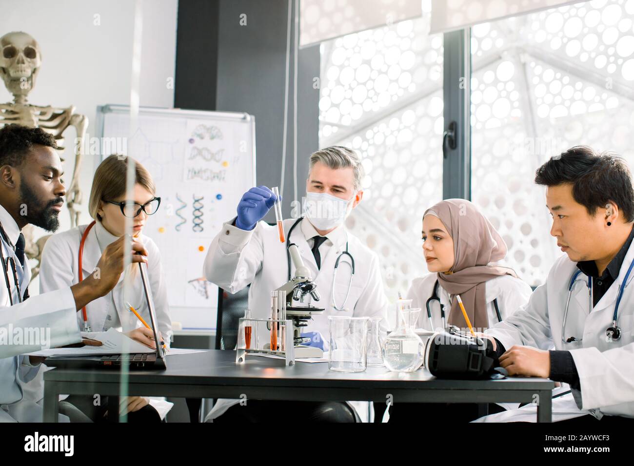 science, chemistry, medicine, pharmacy and people concept. Young ...