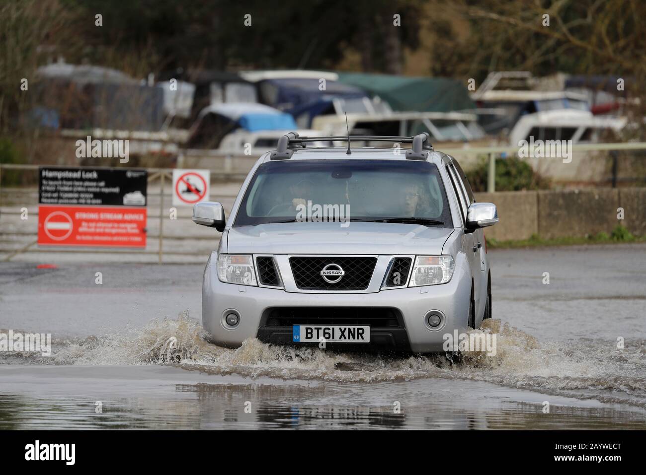 A car passes through a flooded road as the water rises near Yalding in ...