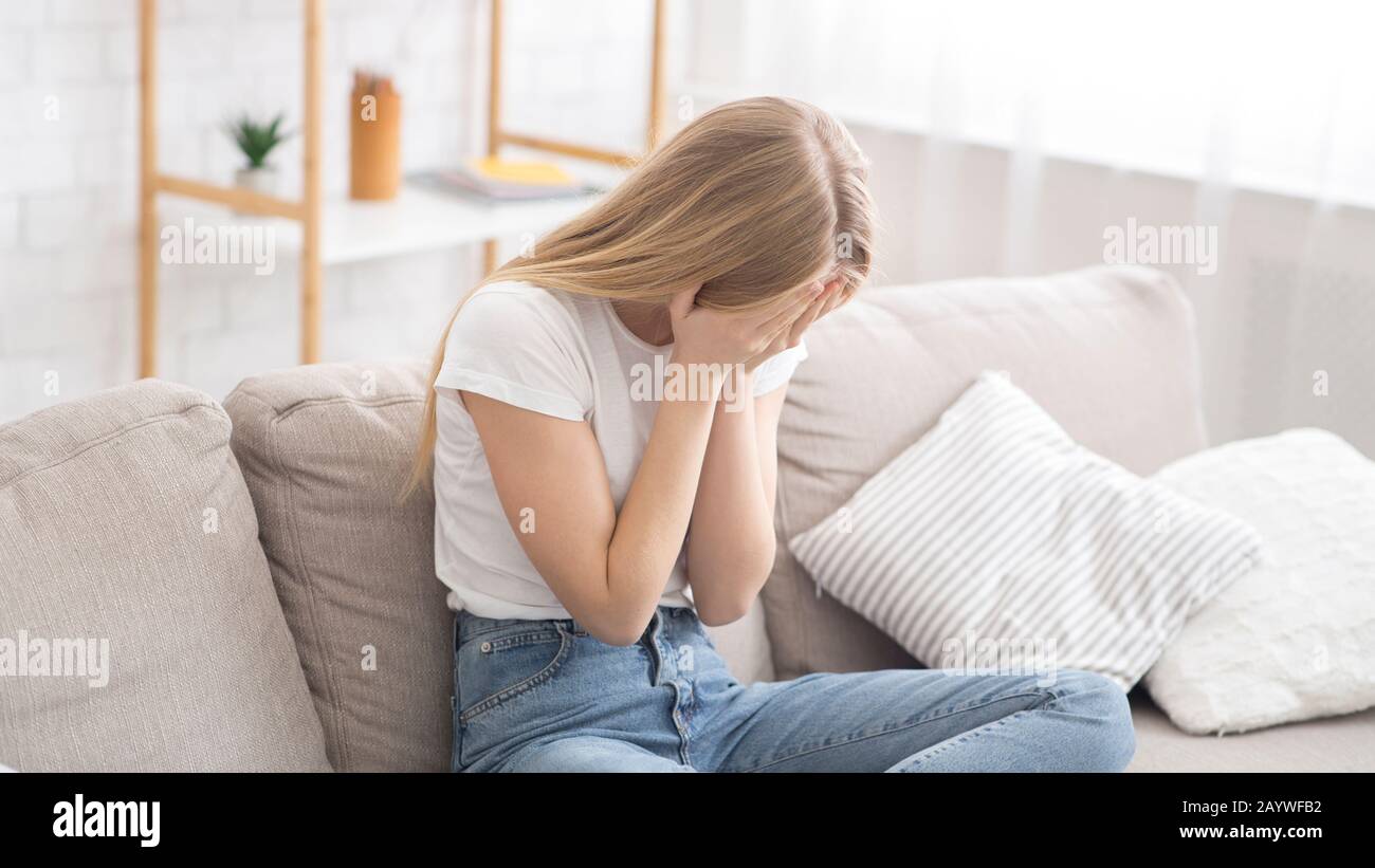 Woman And Sad And Alone And Couch Stock Photos & Woman And Sad And ...