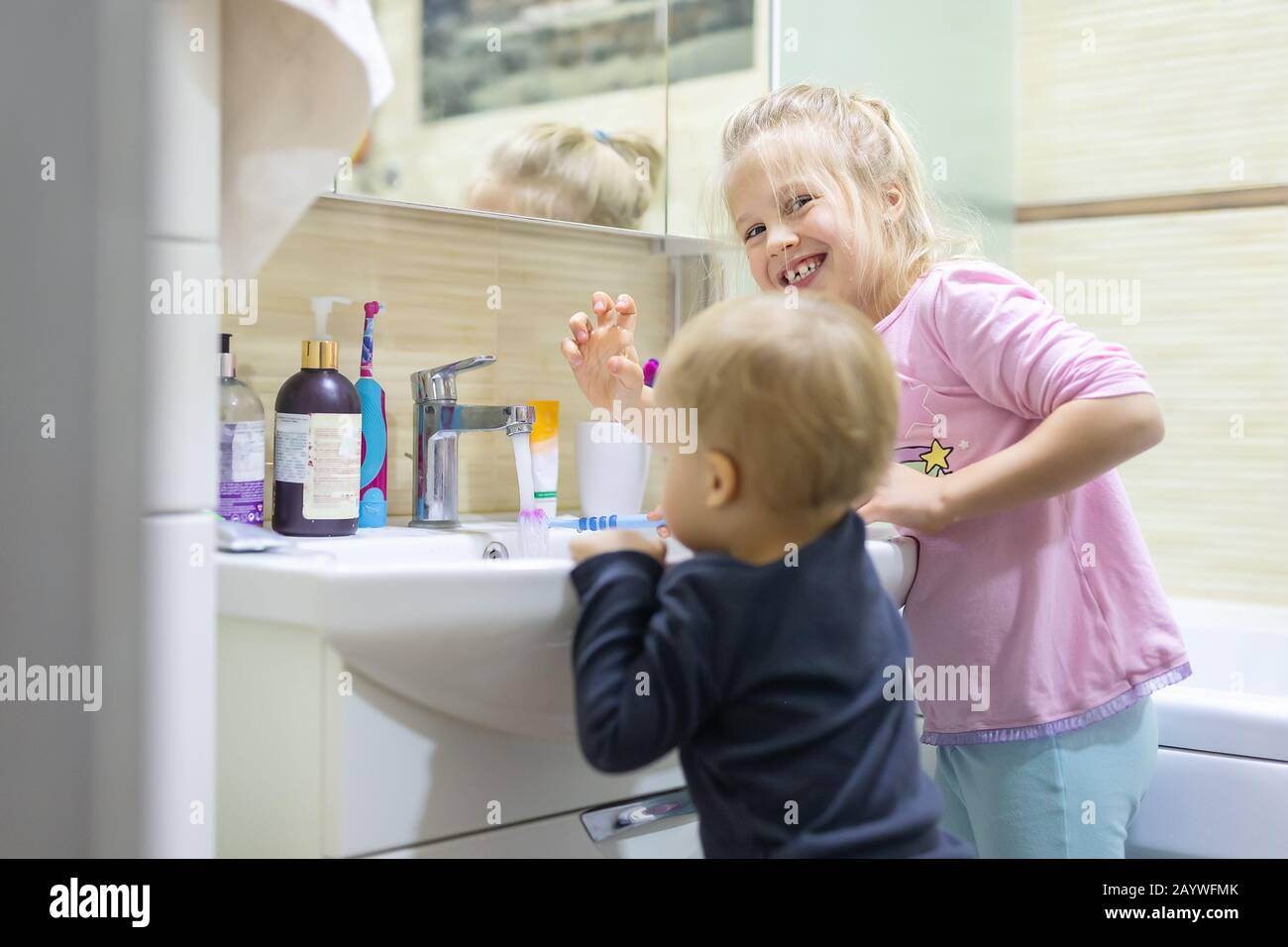 Child washing face sink hi-res stock photography and images - Alamy