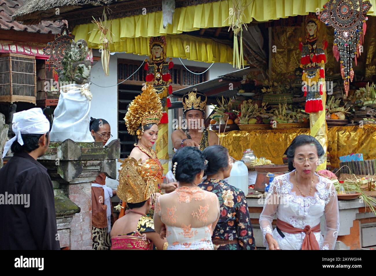 A Balinese Hindu priest gives blessing to a bride in a traditional ...