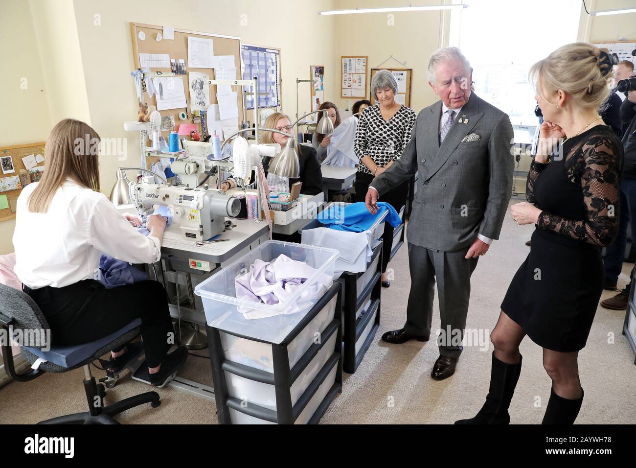 The Prince of Wales talks to Emma Willis (right) and employees during his visit to bespoke shirt ...