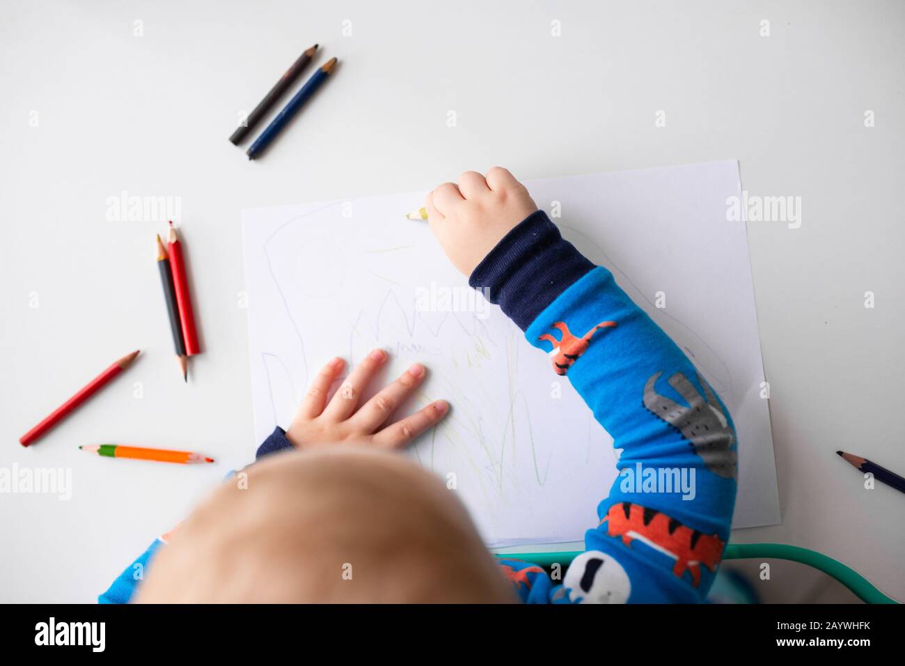Baby boy drawing a picture with colored pencils, focus on hands Stock ...