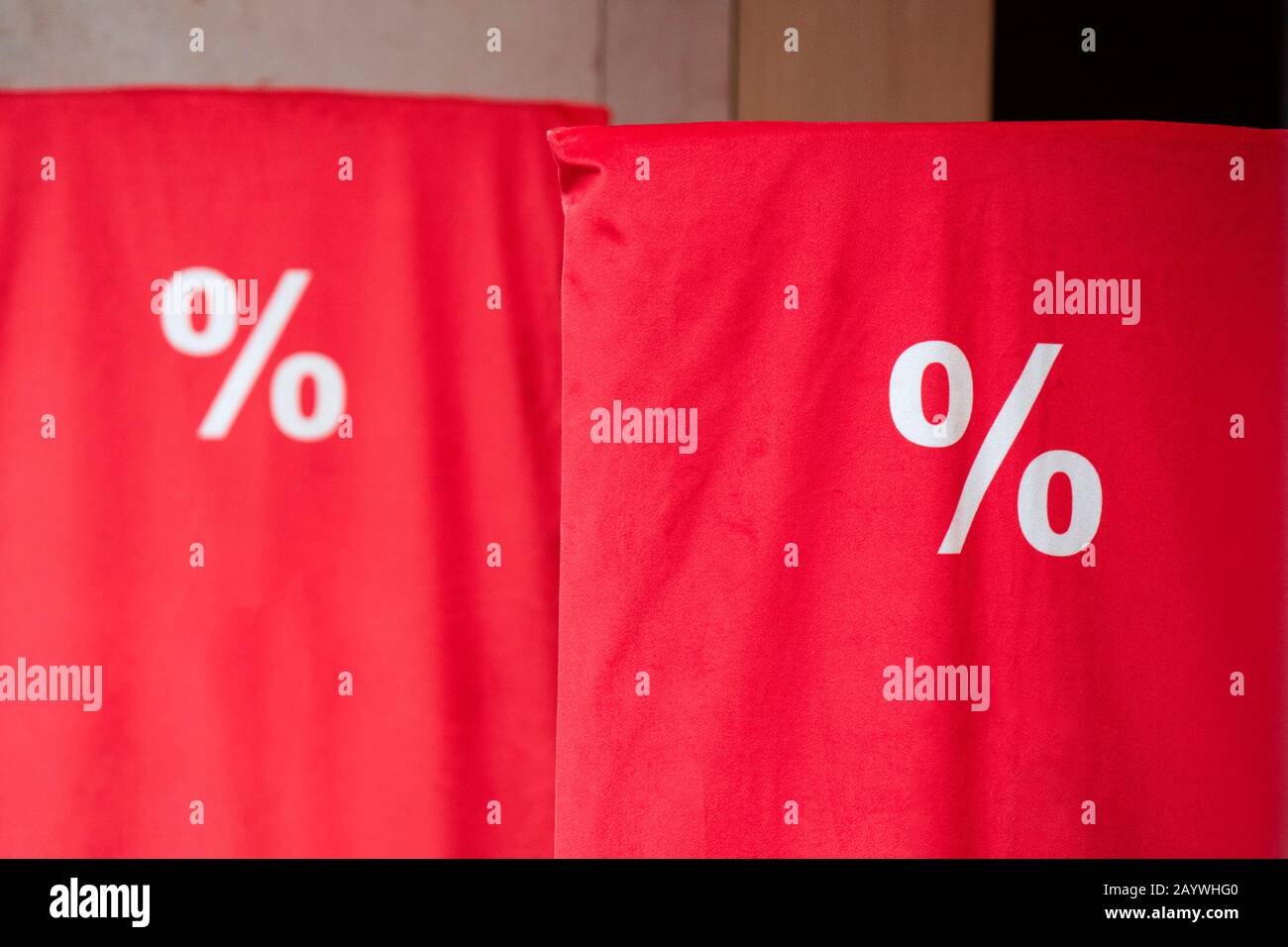 Percent sign close-up written on a red rectangular cloth. There is a ...