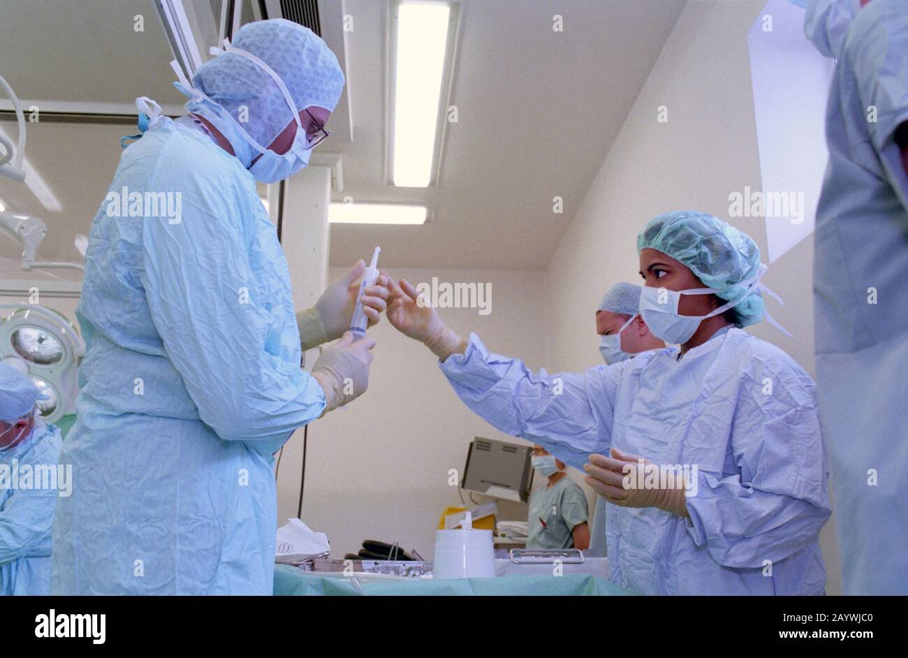 scrub nurse and a surgeon preparing for a surgical proceedure Stock ...