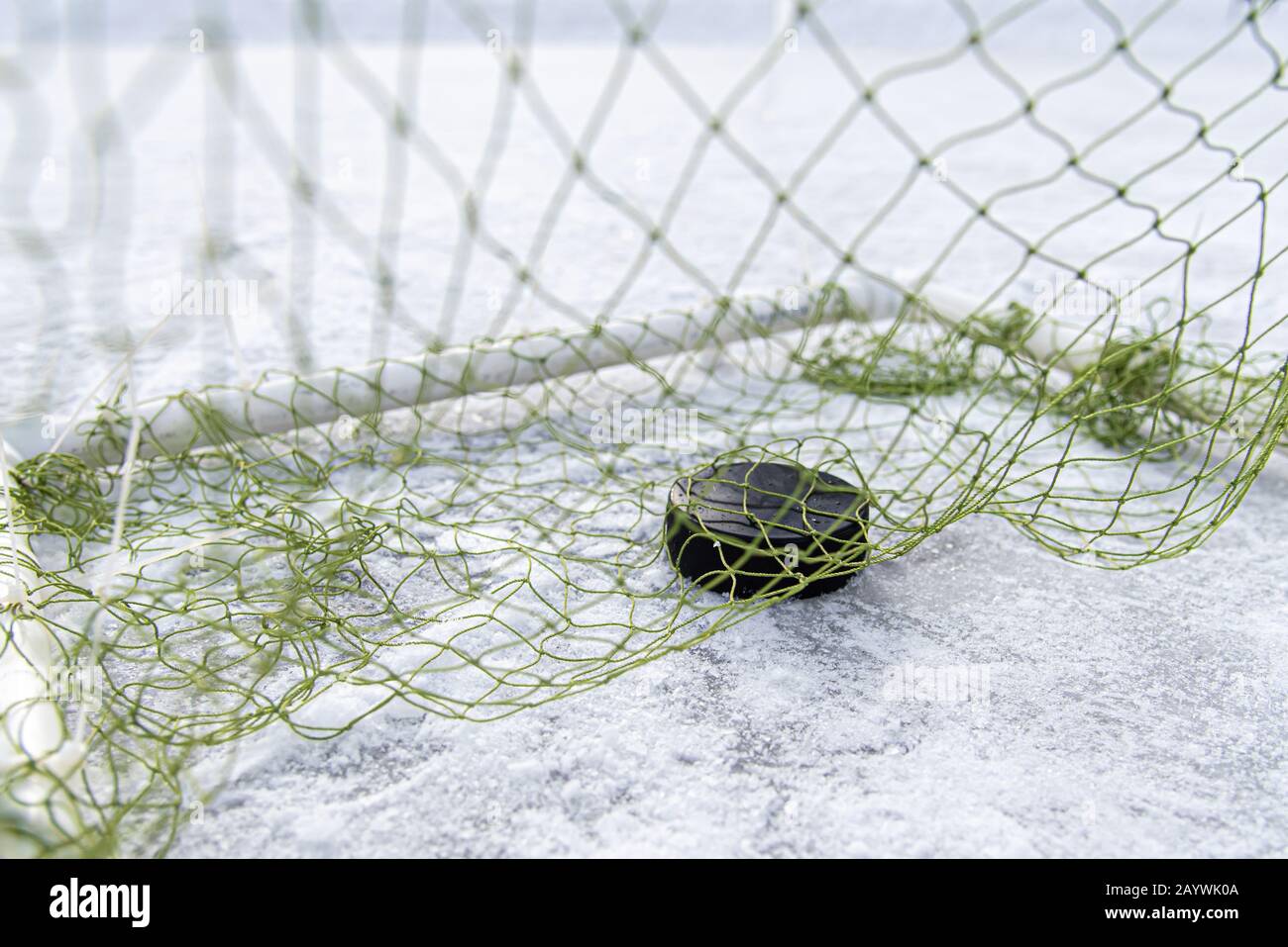 Hockey puck in goal at the stadium Stock Photo - Alamy