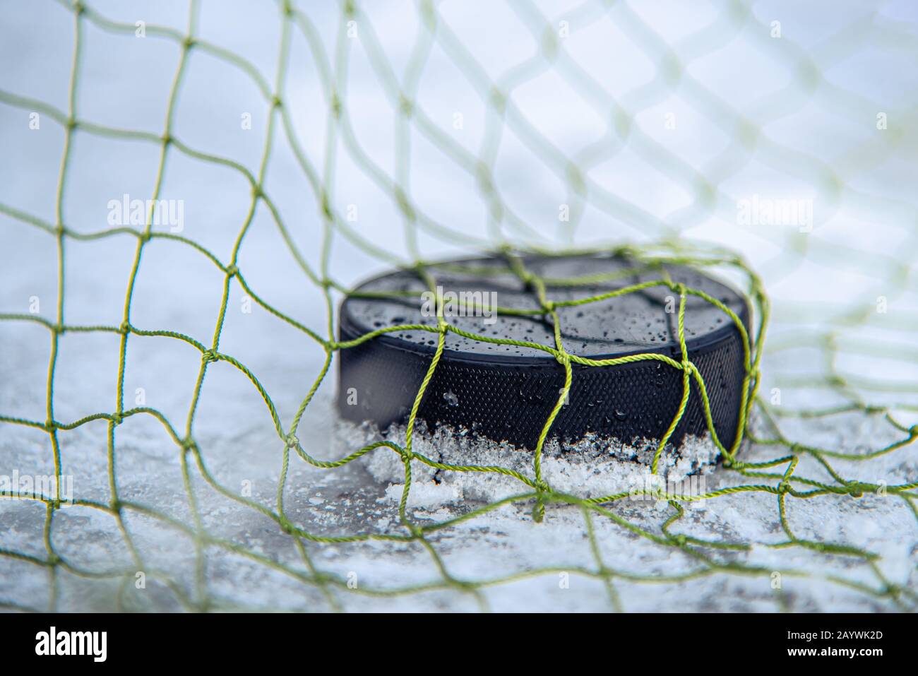 Hockey puck in goal at the stadium Stock Photo - Alamy