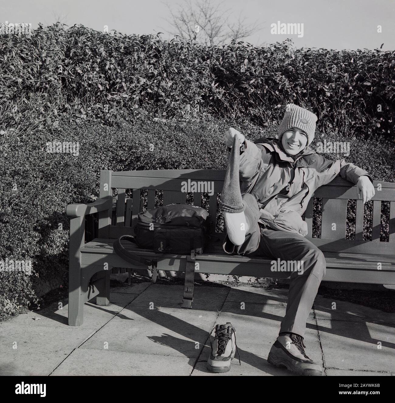 1980s, female adult walker wearing hiking gear and beanie hat sitting ...