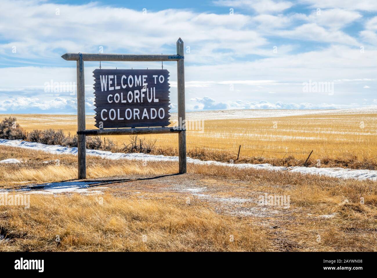 welcome to colorful Colorado roadside wooden sign at a border with Utah ...