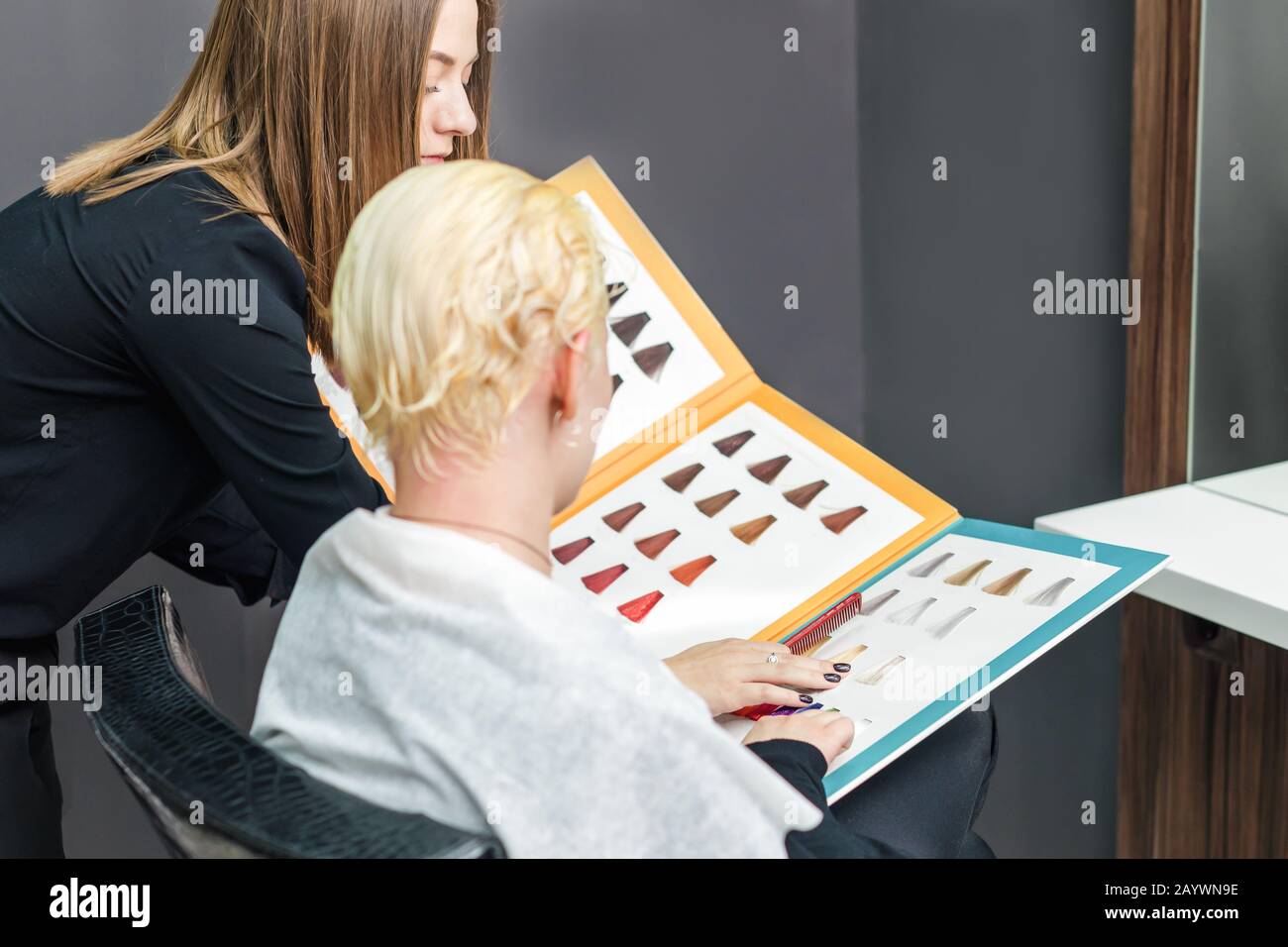 Female selecting hair color from color palette in beauty salon, close ...