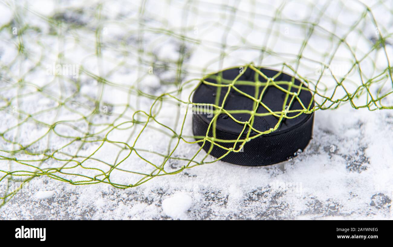 Hockey puck in goal at the stadium Stock Photo - Alamy