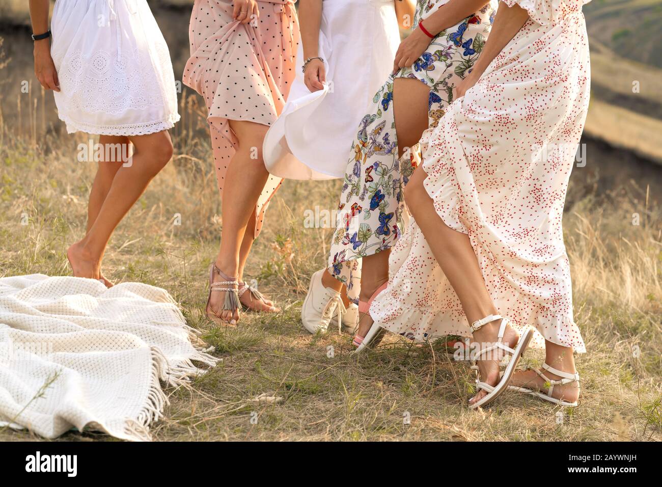 The company of female friends having fun, dancing on summerfield in ...