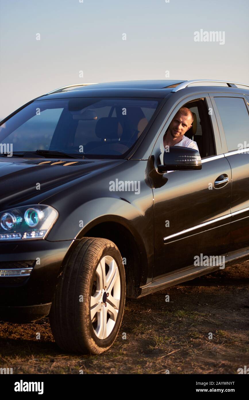Handsome man looking out the window of the car hi-res stock photography ...