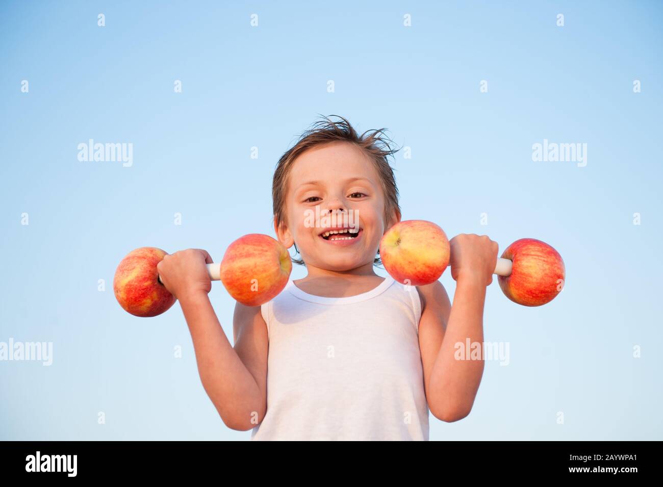 strong healthy active little kid in white tank top lifting heavy ...