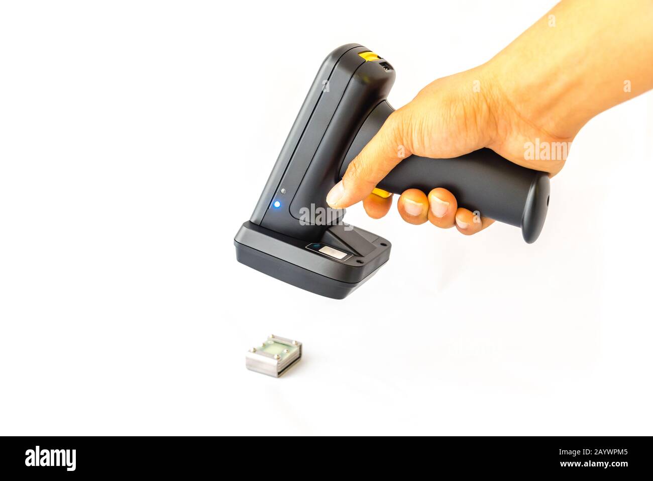 Working barcode reader in Asian male hand scanning metal RFID tag ...