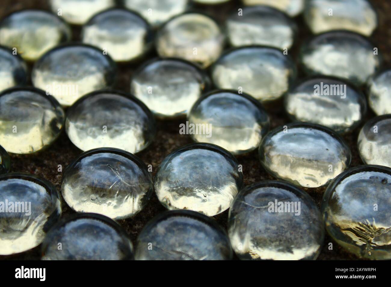 The picture shows many glass beads on stone floor Stock Photo - Alamy