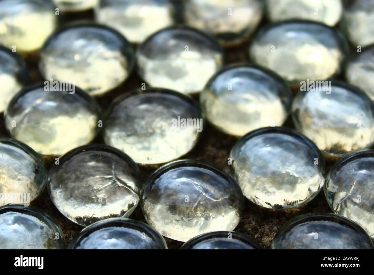 The picture shows many glass beads on stone floor Stock Photo - Alamy