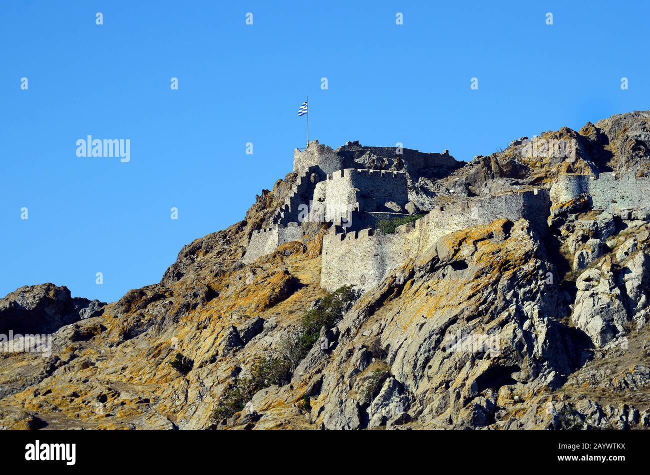 Greece, Greek flag and ruins of fortress in Myrina on Lemnos island ...