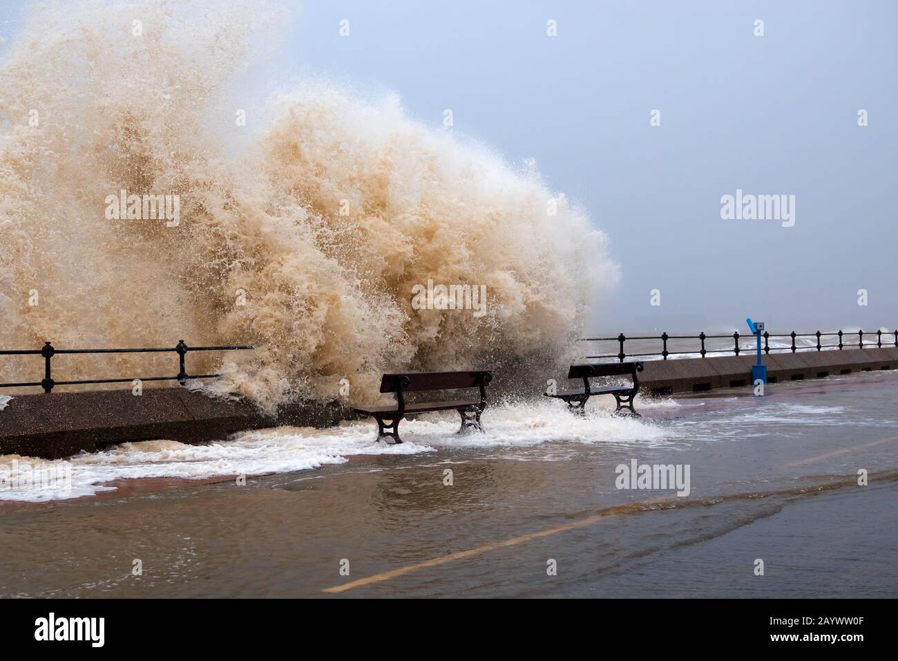 Waves crash over the promenade walls at New Brighton Merseyside during ...