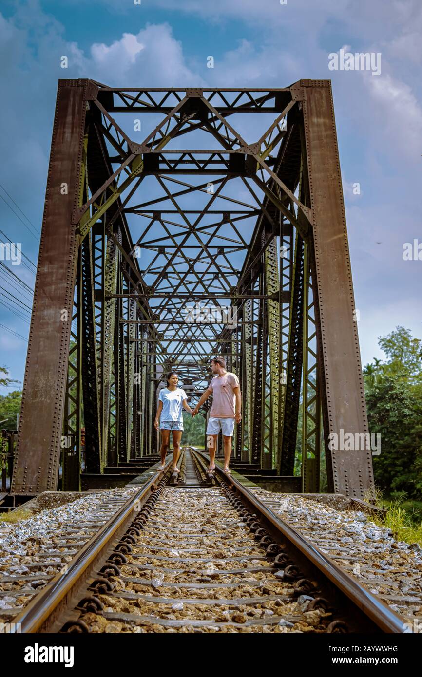 Lang Suan railroad over the river in Chumphon Thailand, couple walking ...
