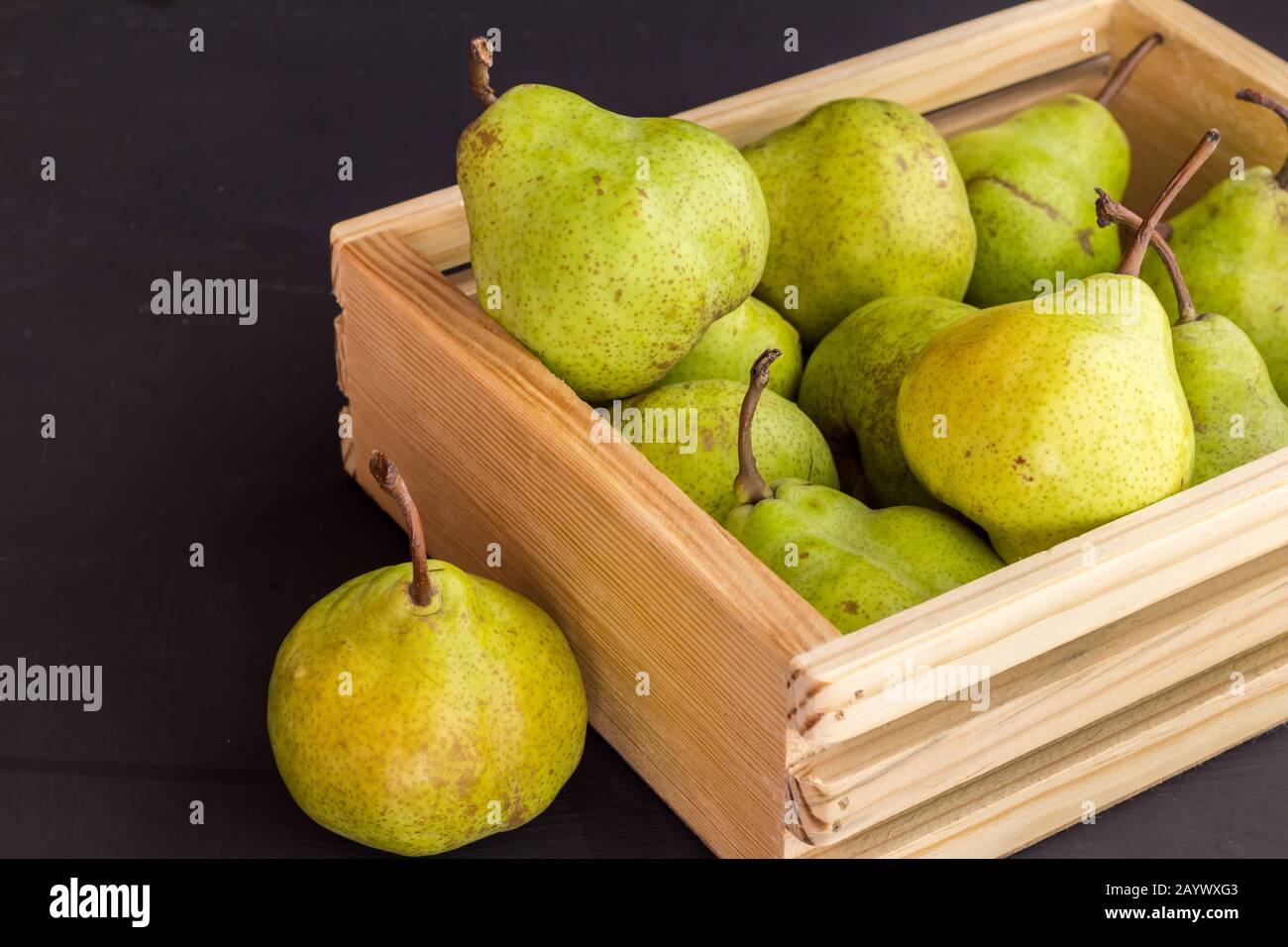 Crate of pears close up isolated on black background - horizontal image ...