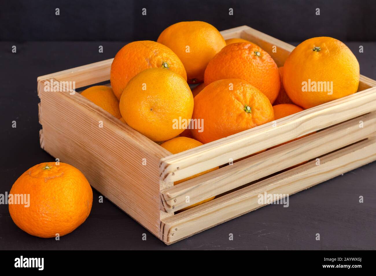 Oranges in a crate isolated on black background - horizontal image ...