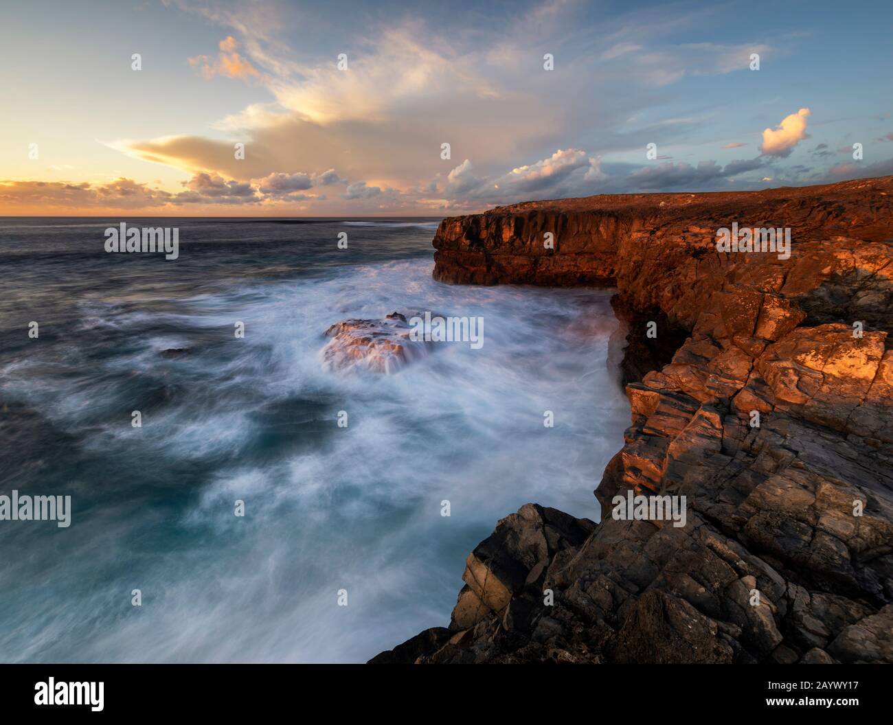 beautiful and dramatic sunset on a craggy rocky cliff, Jandia Peninsula ...