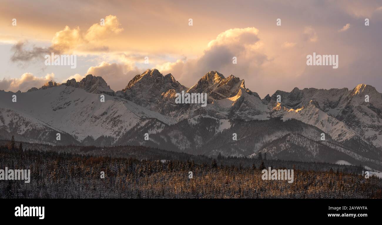 Snow-covered peaks of the Tatra Mountains in the light of the rising ...
