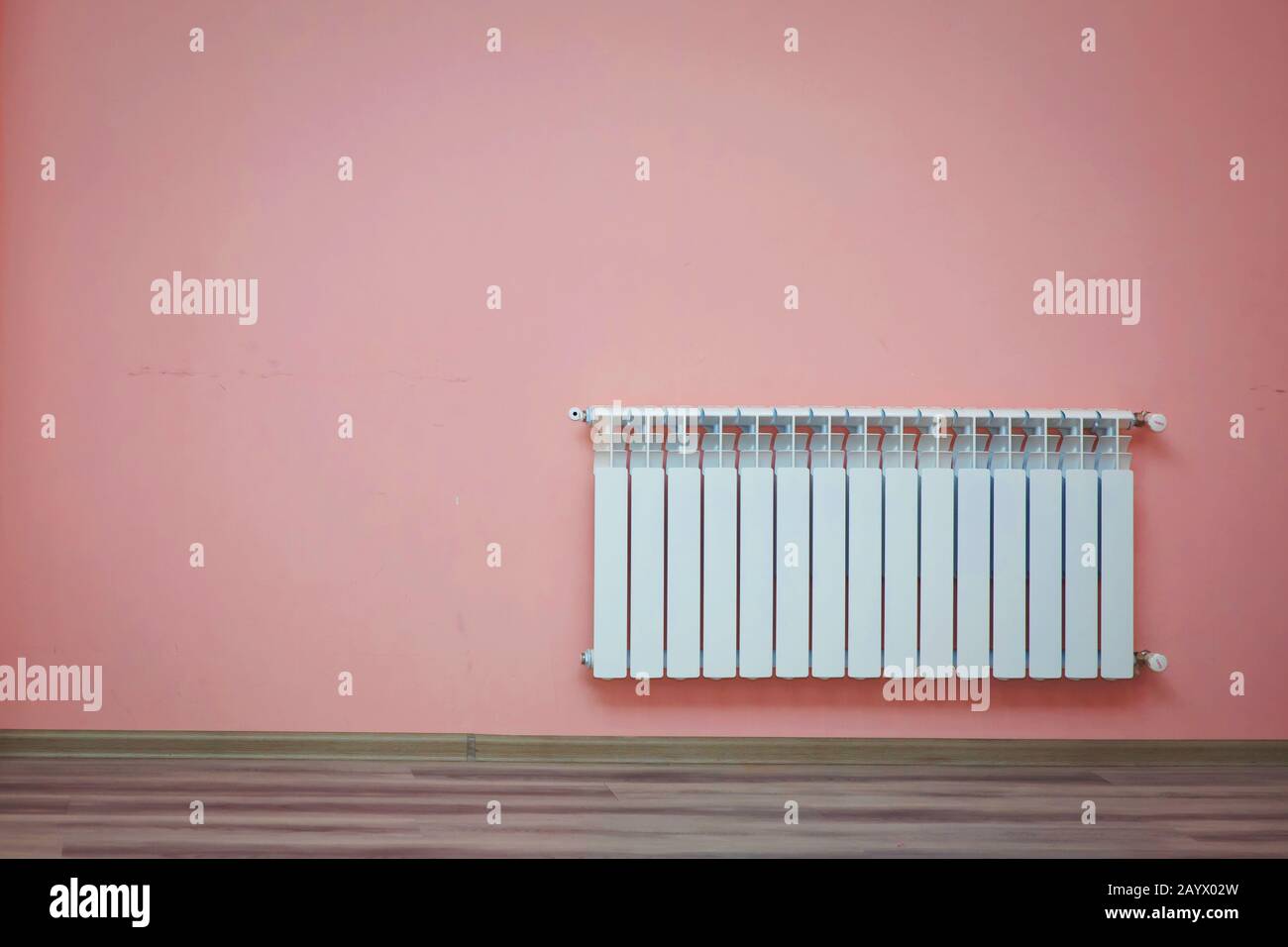 home gas heater closeup .Heating radiator on a pink wall at an ...