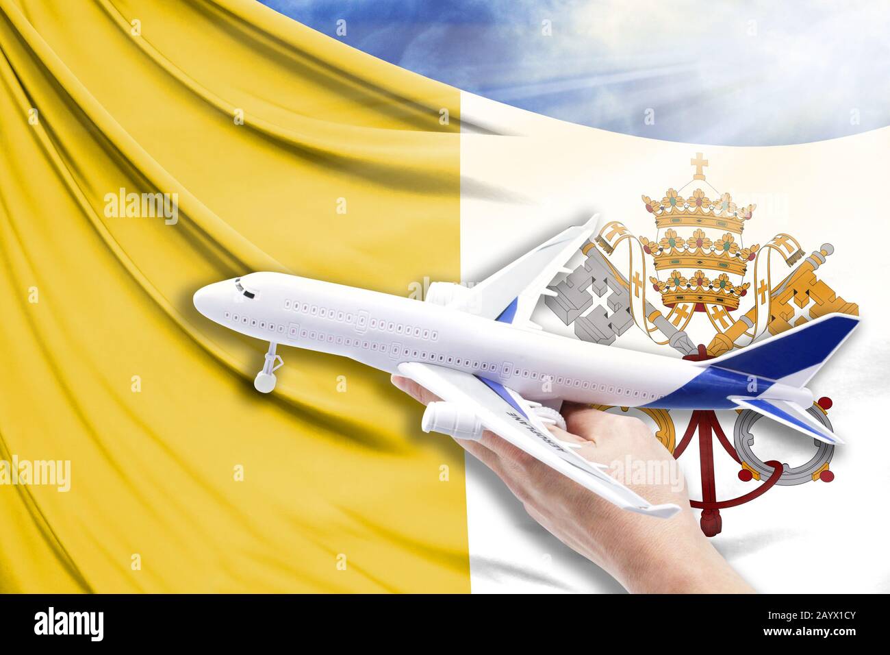 Airplane in hand with national flag of Vatican city Holy see on a ...