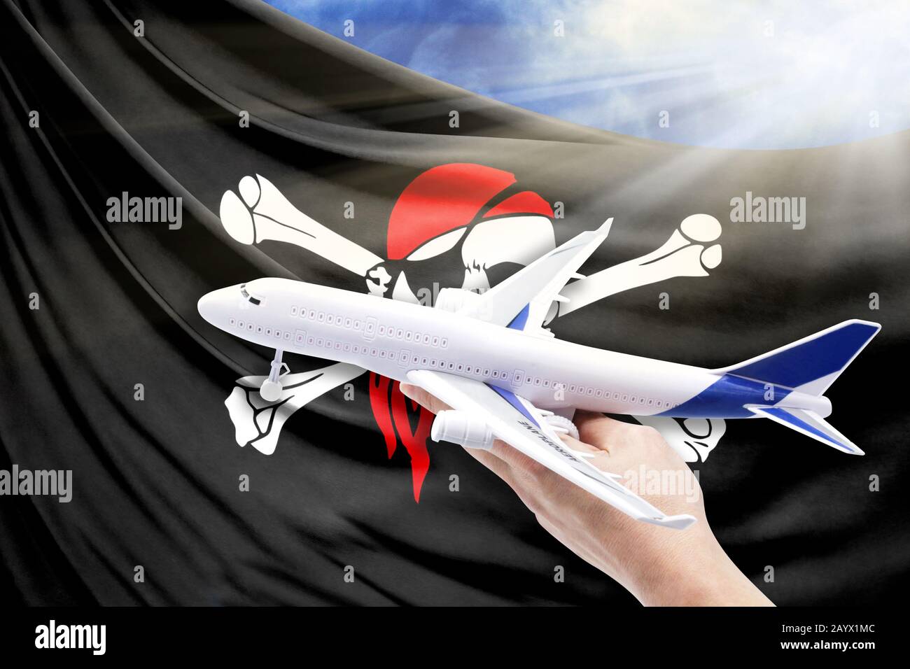 Airplane in hand with national flag of pirate on a background of blue ...