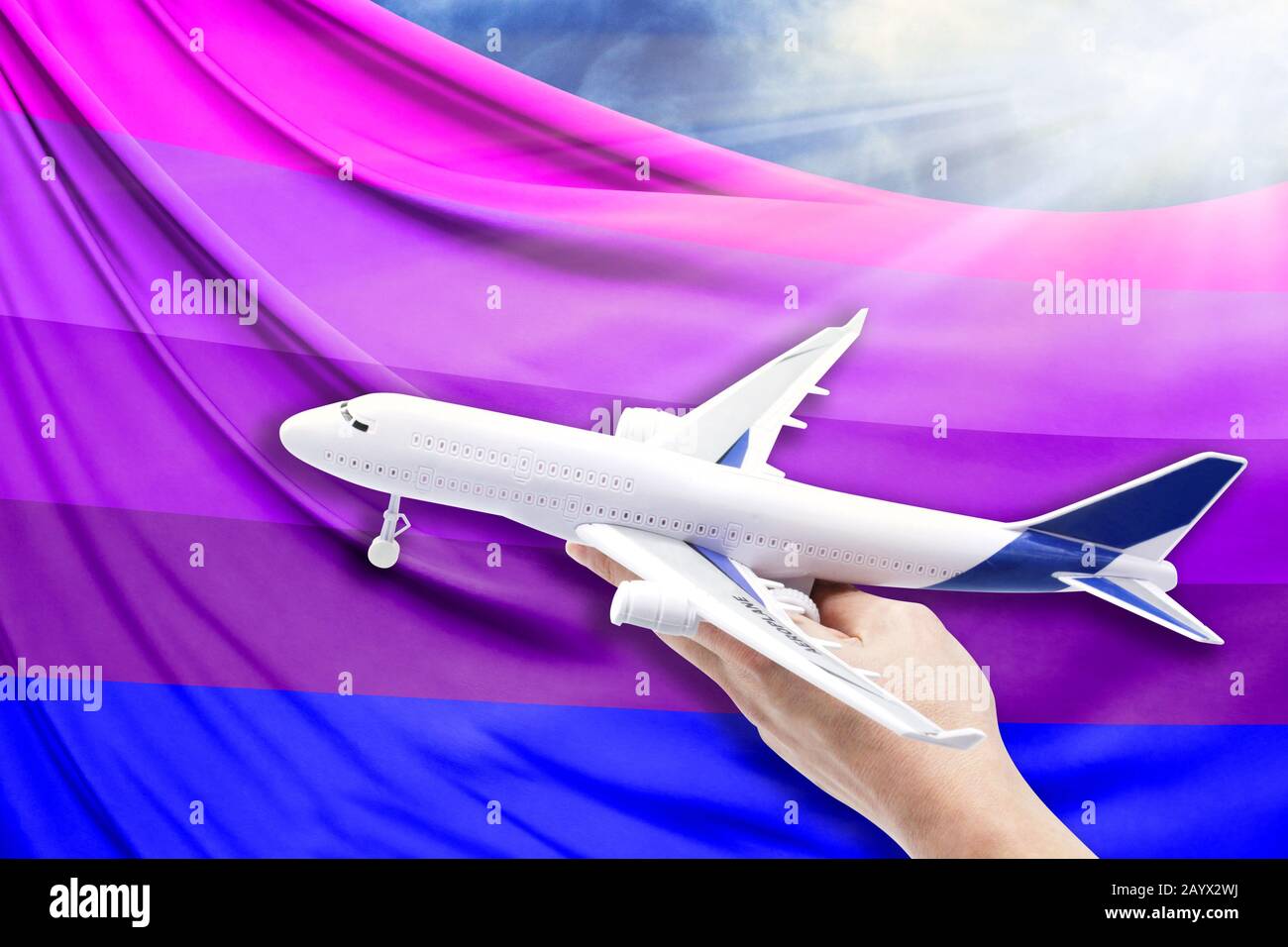 Airplane in hand with national flag of Alternative Transgender pride on ...