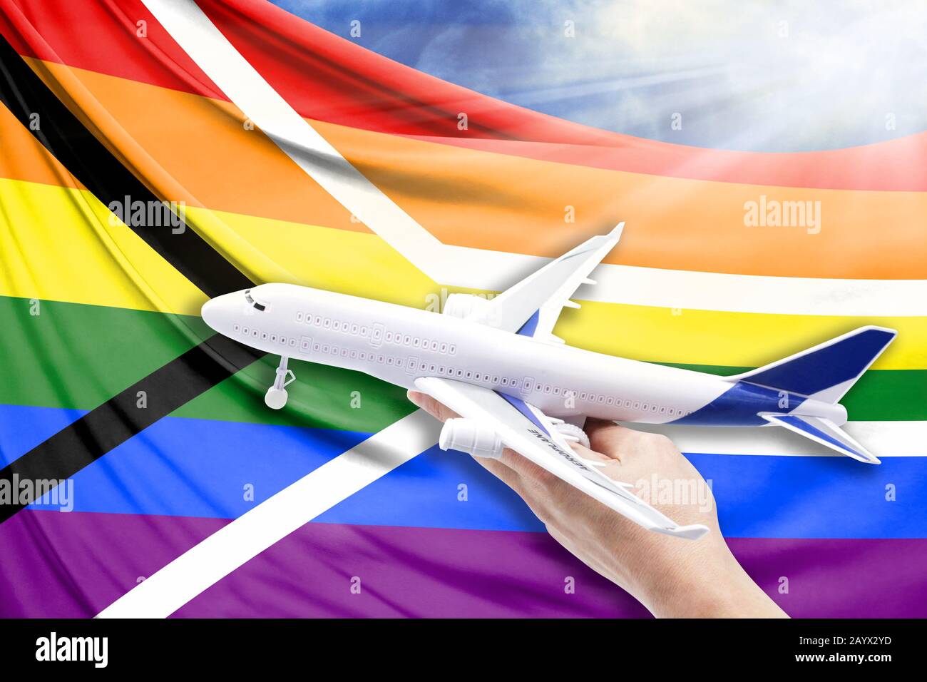 Airplane in hand with national flag of Gay pride Flag of South Africa ...